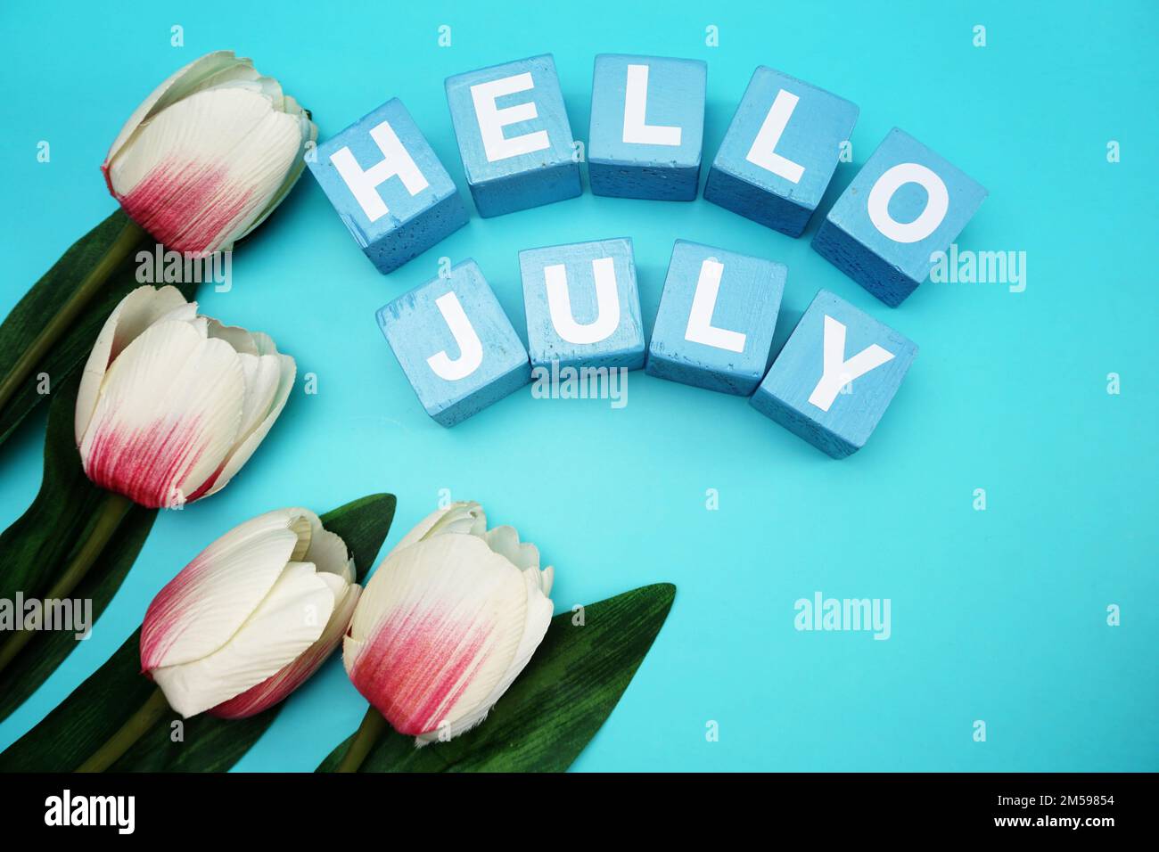 hello july with artificial pink tulip flower on blue background Stock ...