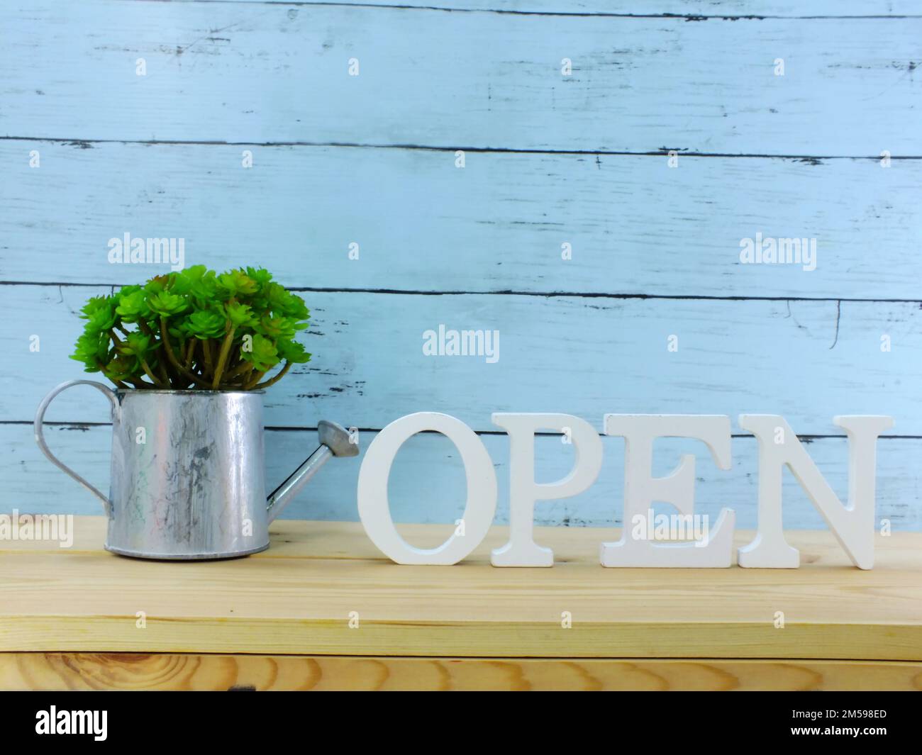open wooden letter alphabet on wooden background Stock Photo - Alamy