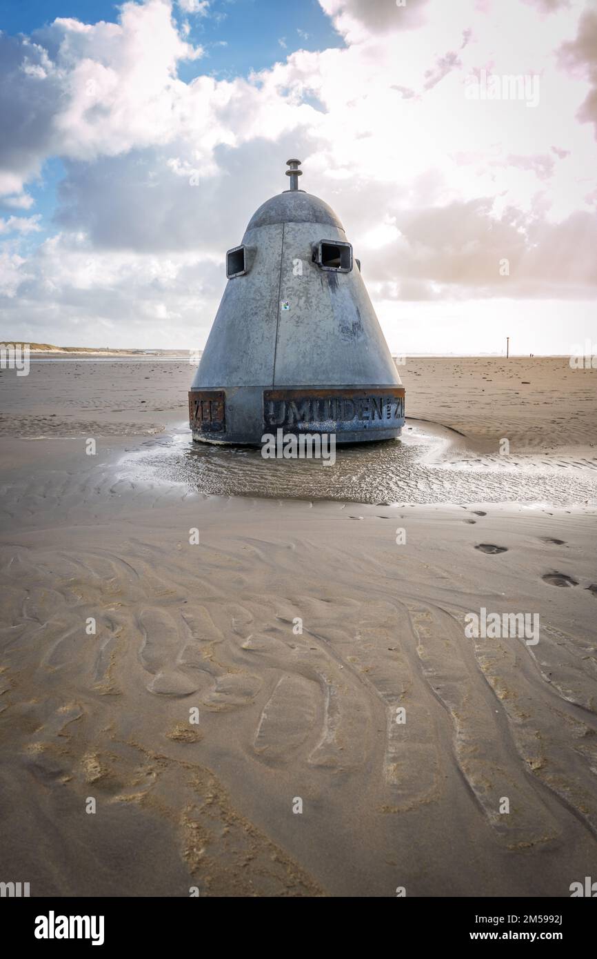 A vertical shot of a bouy on the beach during low tide Stock Photo - Alamy