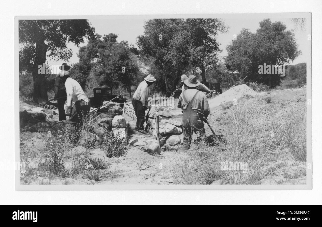 Original caption: "Manzanita. Indians building dry rubble culvert ...