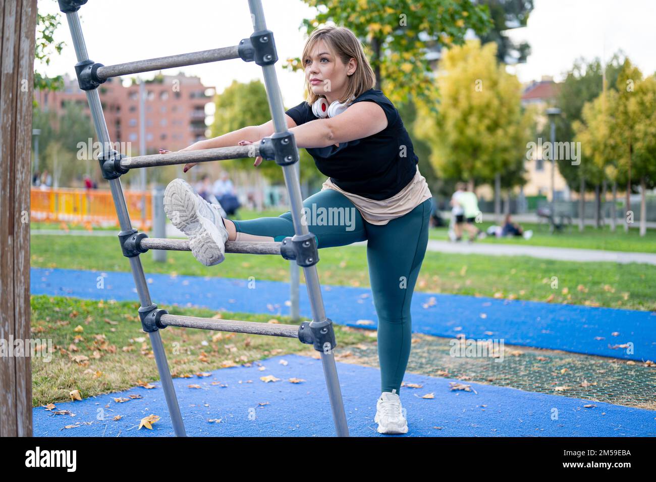 Young plus size woman doing stretching outdoor, attractive and ...