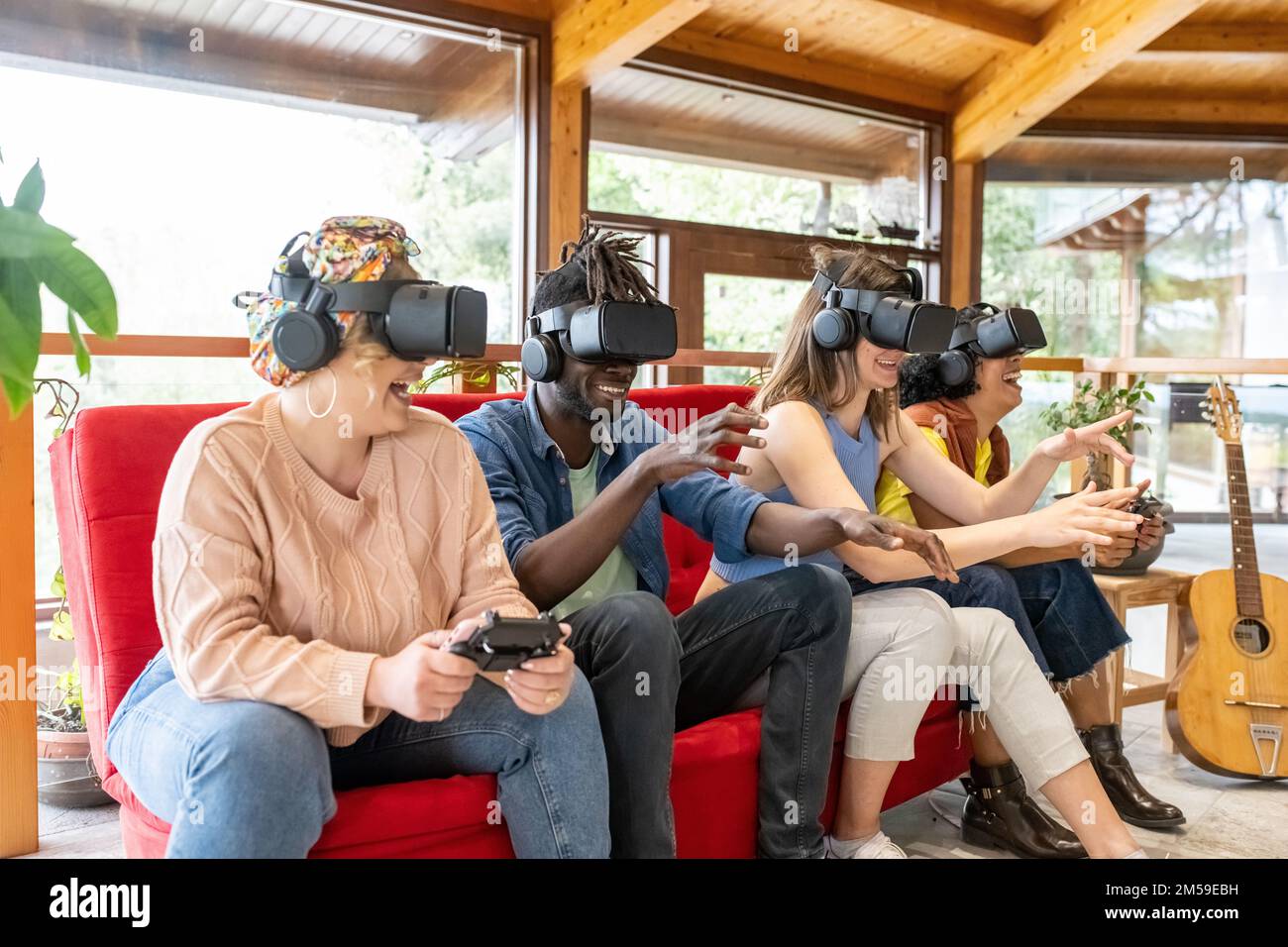 Playful afternoon of a multi-ethnic group of friends, team of gamers ...