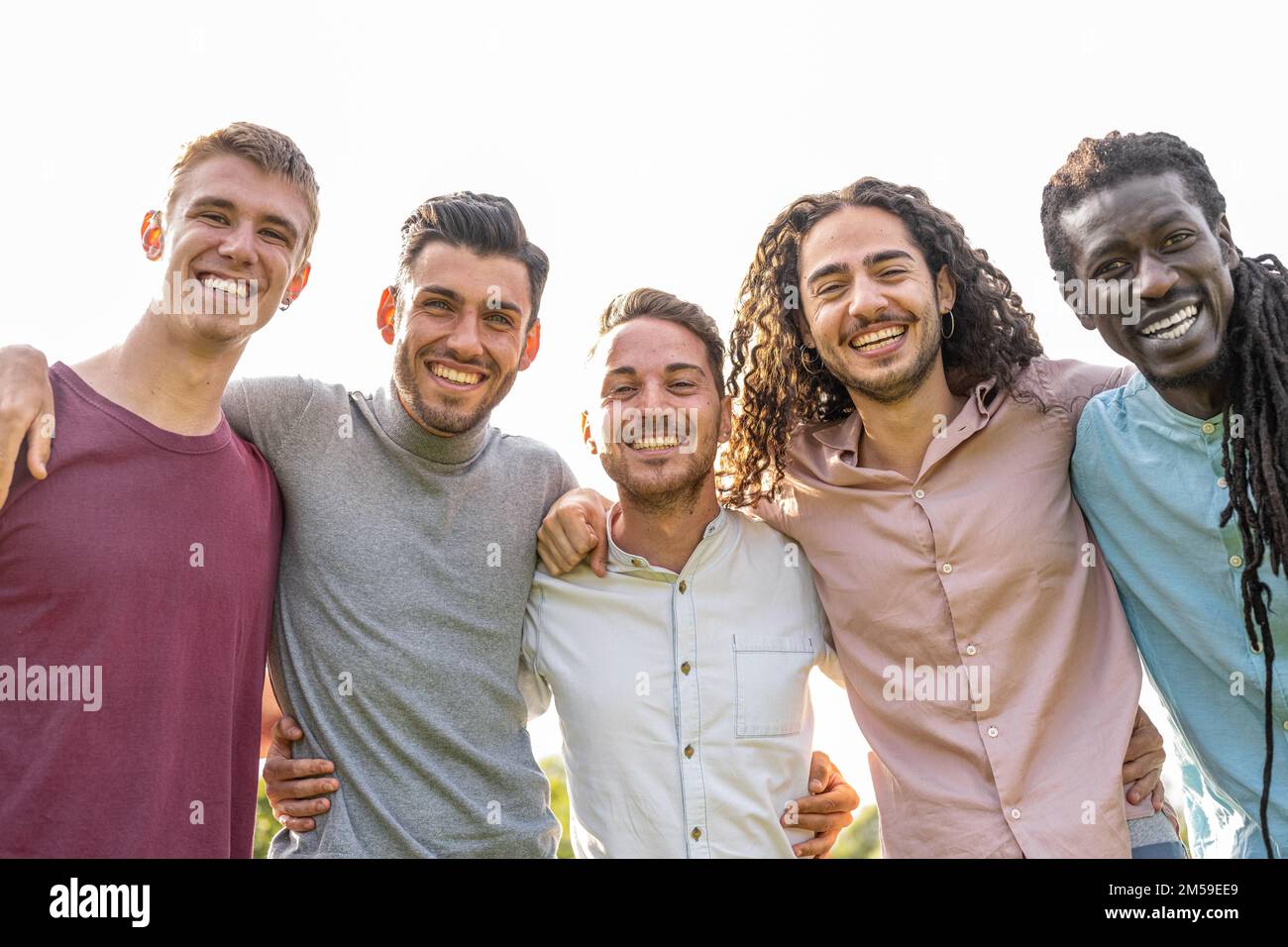Five young men, happy friends and brothers, family reunion Stock Photo ...