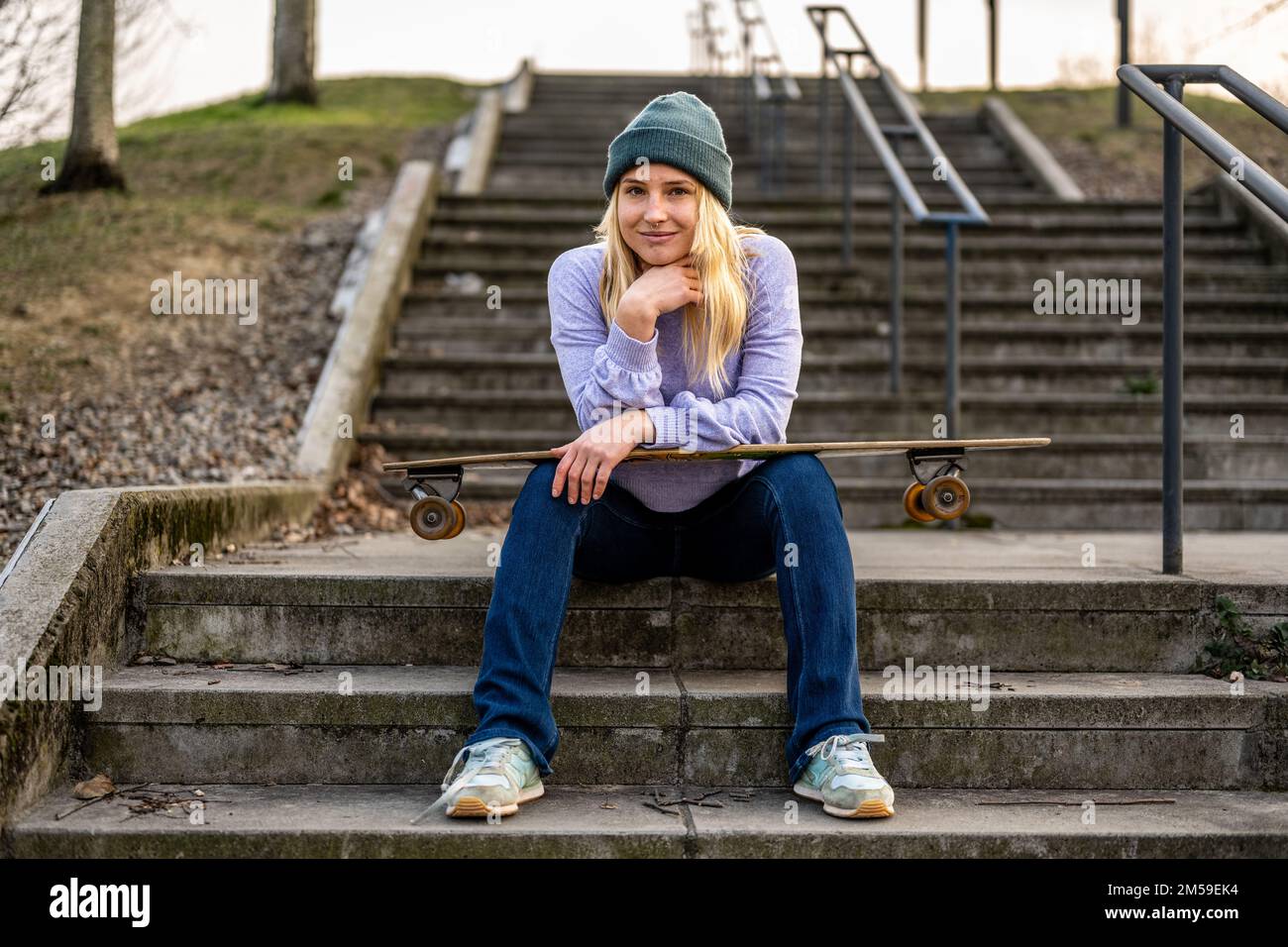 Young woman with skate, portrait of Generation Z people Stock Photo - Alamy