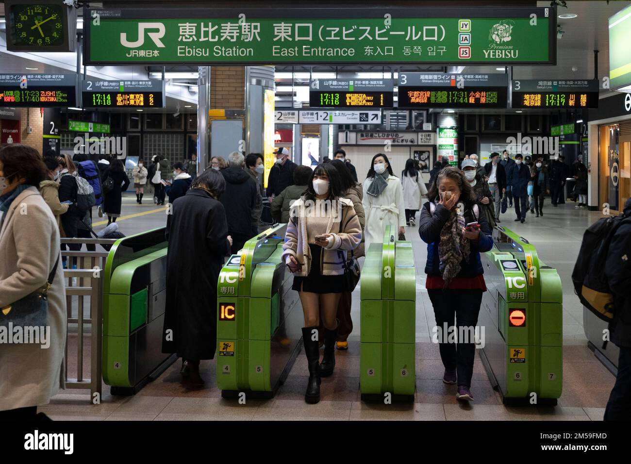 Tokyo, Japan. 26th Dec, 2022. Commuters pass through JR East metro ...