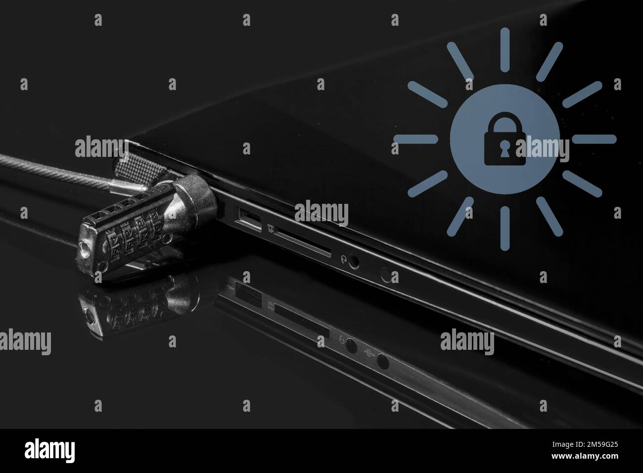 The laptop is locked with a cable lock on surface of dark mirror ...