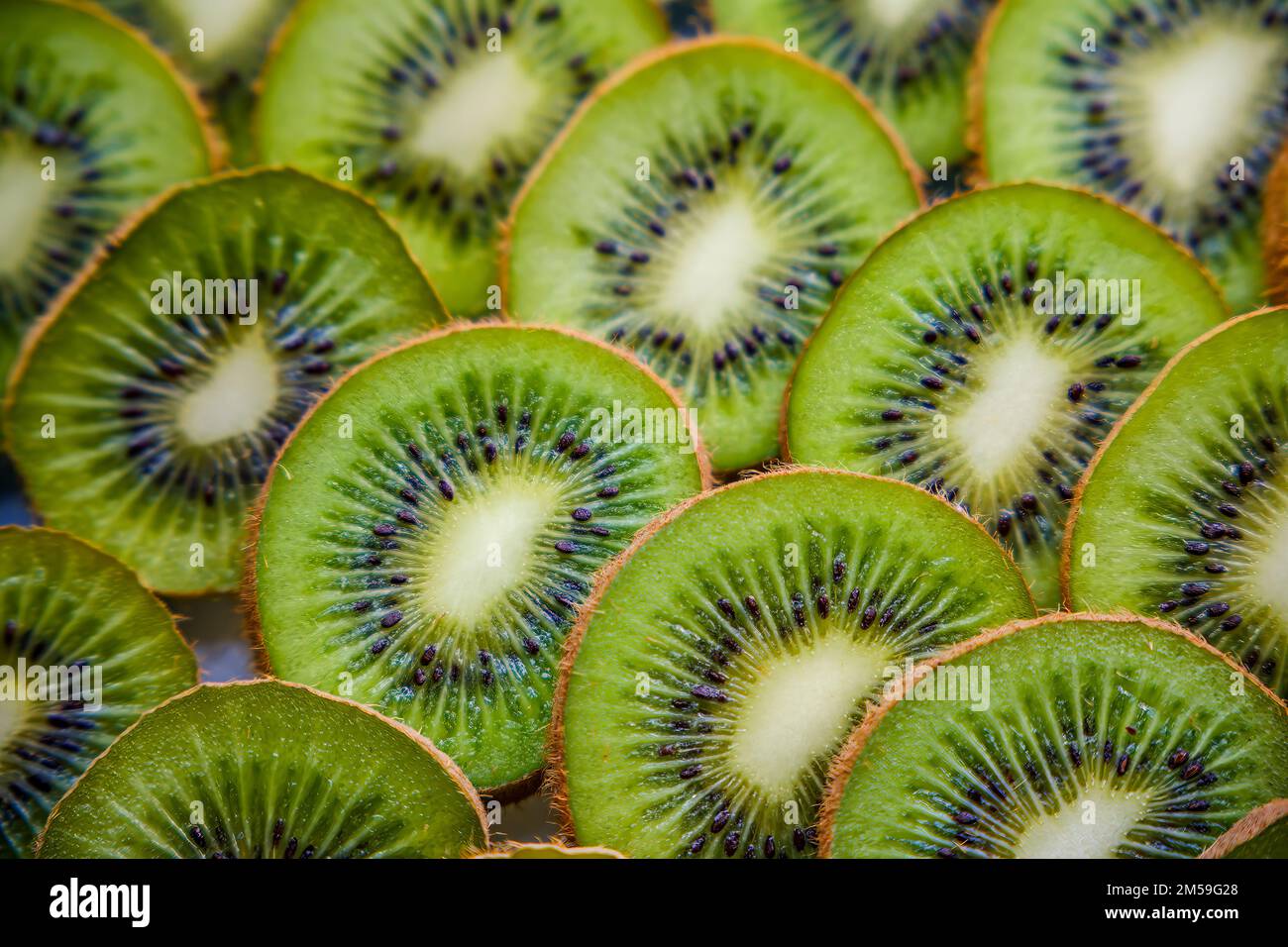 Ripe fresh kiwi fruits sliced as textured background, protein load ...