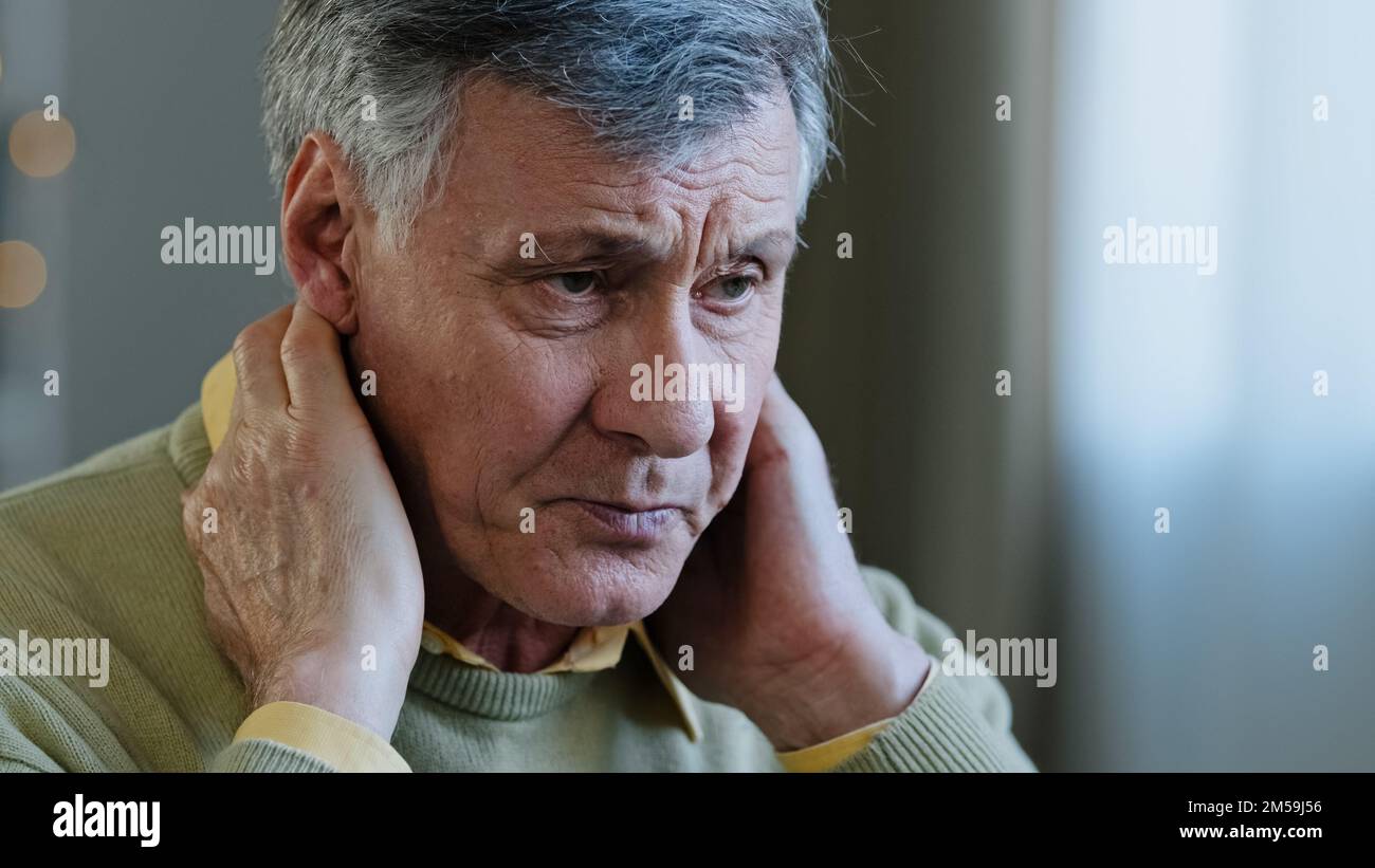 Sad old caucasian man suffer from neck pain 60s upset male tired ...