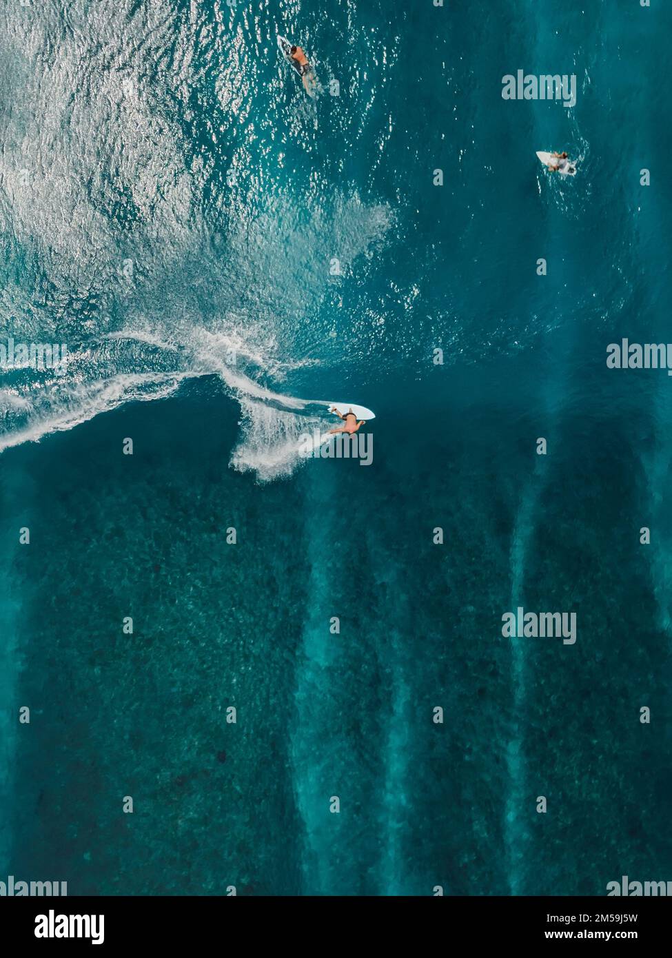 Aerial view with surfier riding on ideal wave. Perfect waves with ...