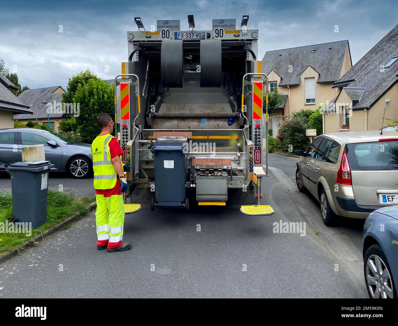 Caen, France 2022. Garbage collection truck, standing next to a yellow ...