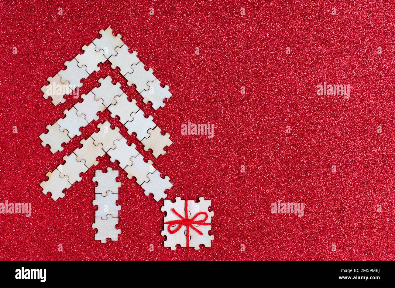 Christmas tree shape and a gift box made from jigsaw puzzle pieces on a ...