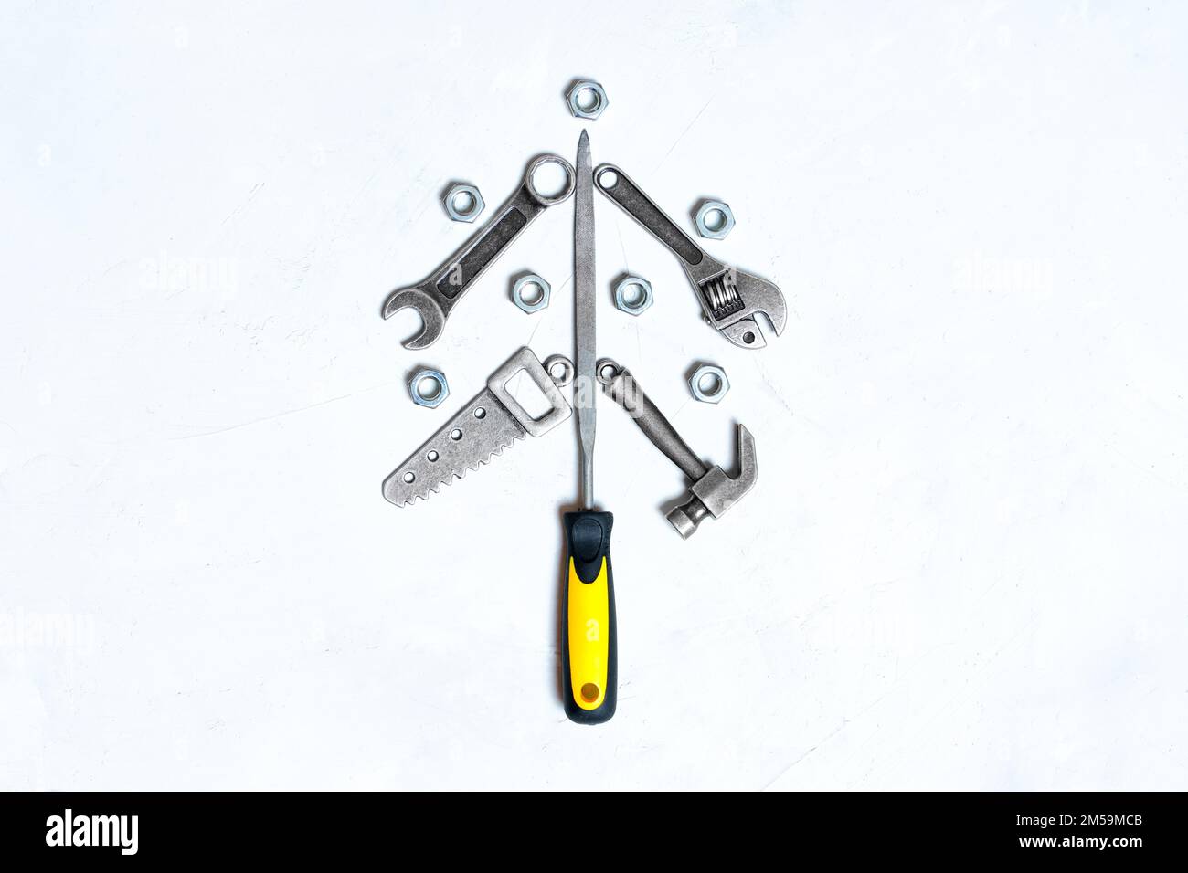 New year tree made from small copies of hand tools and fasteners on ...