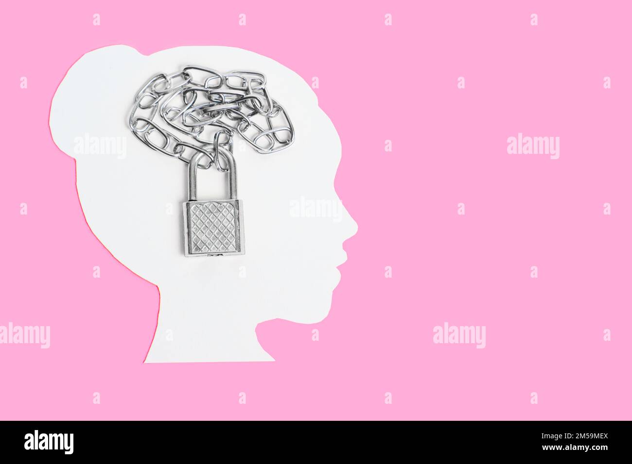 White female head silhouette and chained padlock on pink background ...