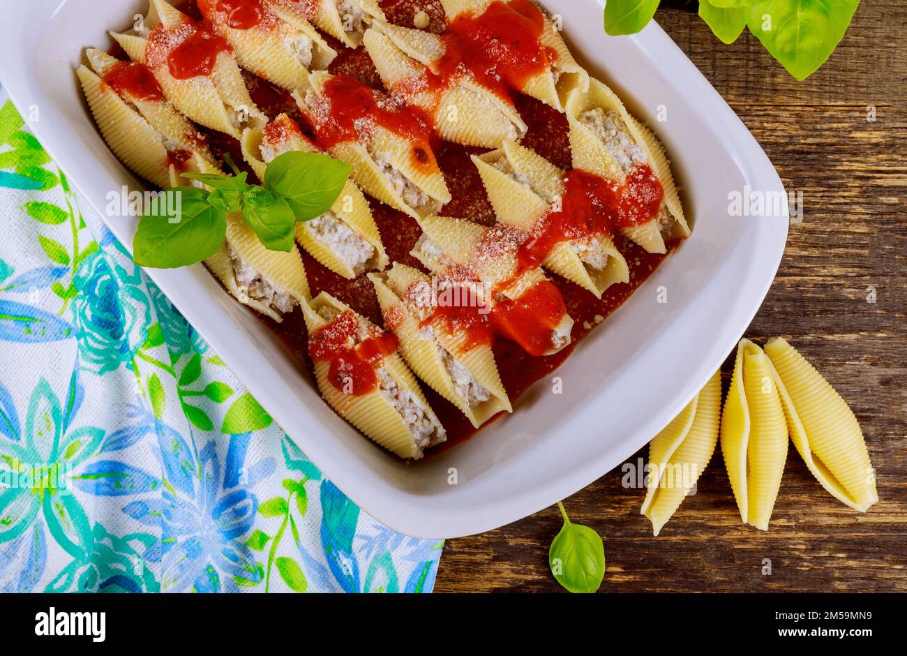 Conchiglioni pasta with ricotta cheese stuffed inside on tomato sauce ...