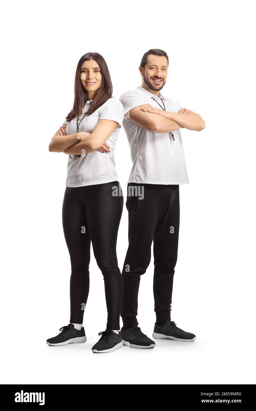 Full length portrait of a male and female sport coaches posing isolated ...