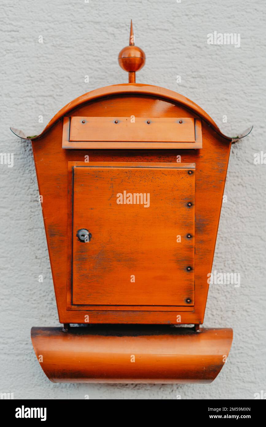 Old orange mailbox on a gray wall Stock Photo - Alamy
