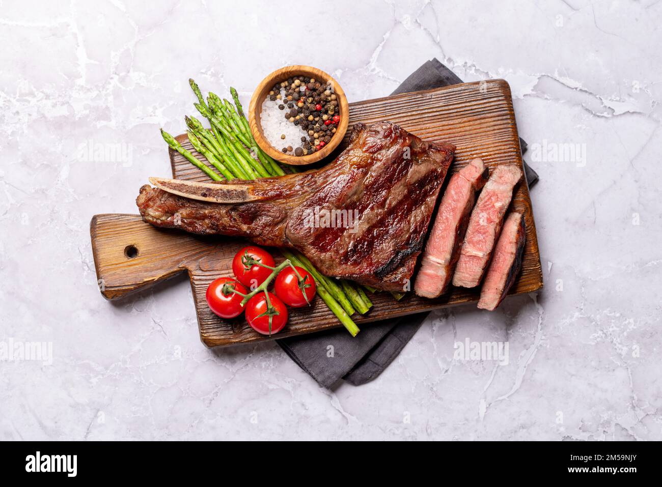 Medium rare grilled Tomahawk beef steak with asparagus. Flat lay Stock ...