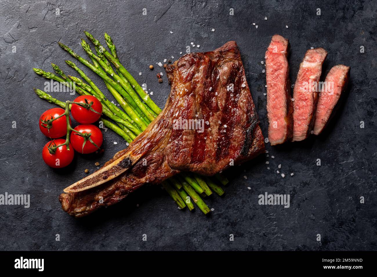 Medium rare grilled Tomahawk beef steak with asparagus. Flat lay Stock ...