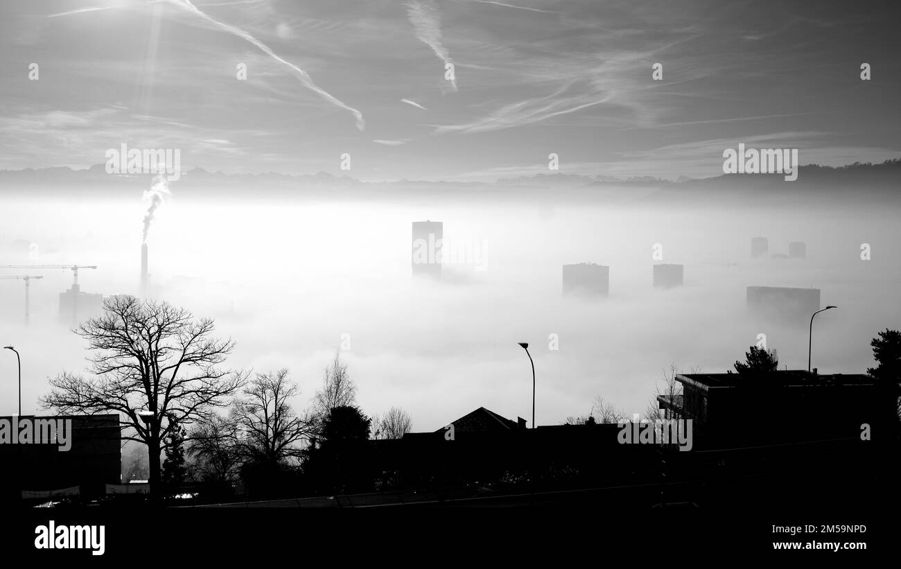 An amazing shot of skyscrapers covered in mist at sunrise Stock Photo ...