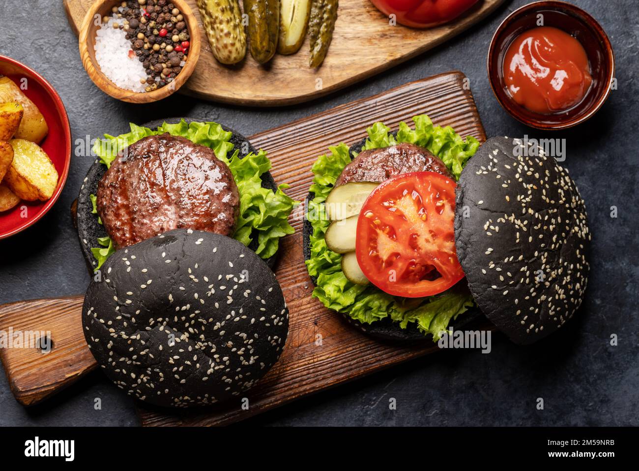 Homemade beef burgers with black buns and french fries. Flat lay Stock ...