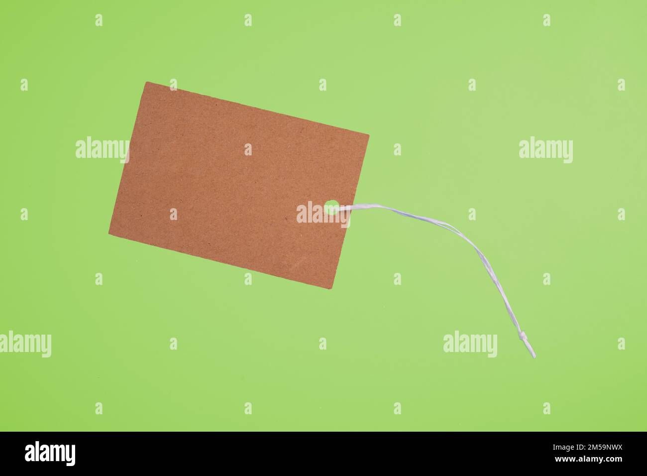 blank paper gift tag isolated on a lime green background Stock Photo ...