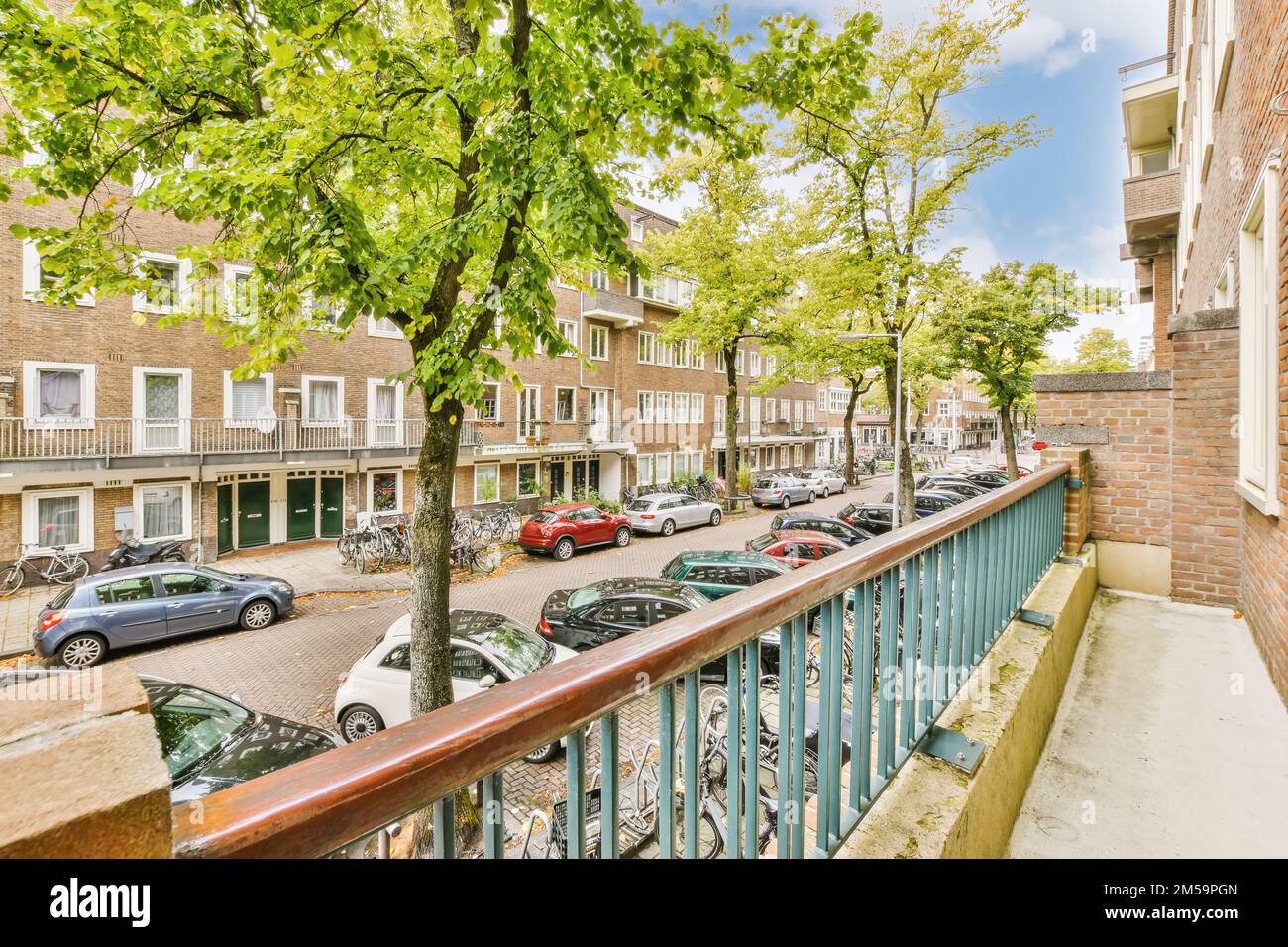 some cars parked on the side of a street in an urban neighborhood, with ...