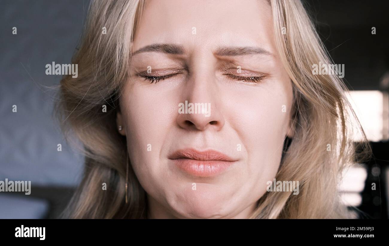 Portrait of crying grieving woman of 30 years. Grimace of sadness with ...