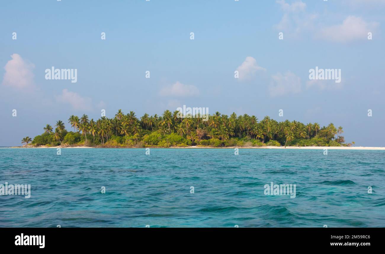 Remote tropical island paradise with shallow lagoon in ocean and thick ...