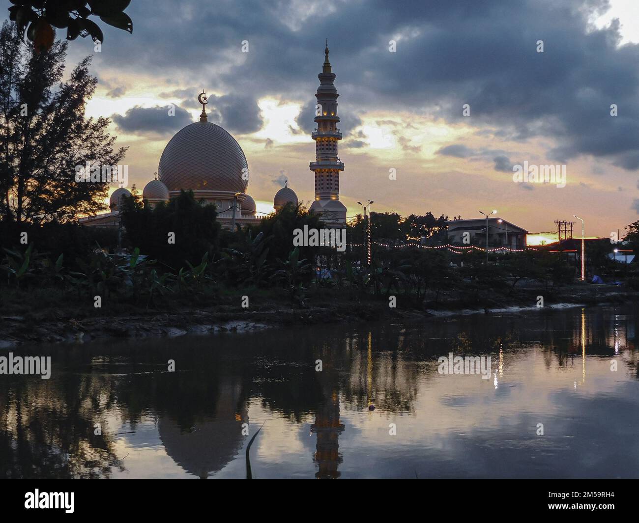 Mosque reflection on water river Stock Photo - Alamy
