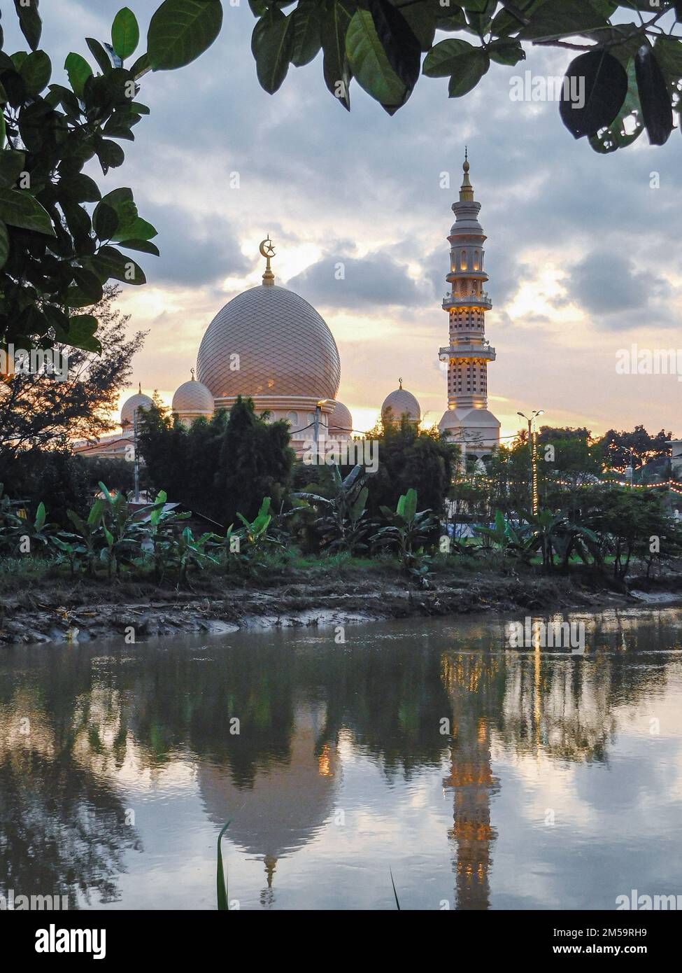 Mosque reflection on water river Stock Photo - Alamy