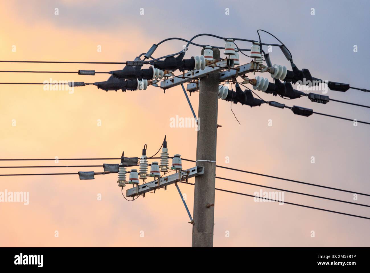 High voltage transmission lines atop electrical pole at sunrise Stock ...