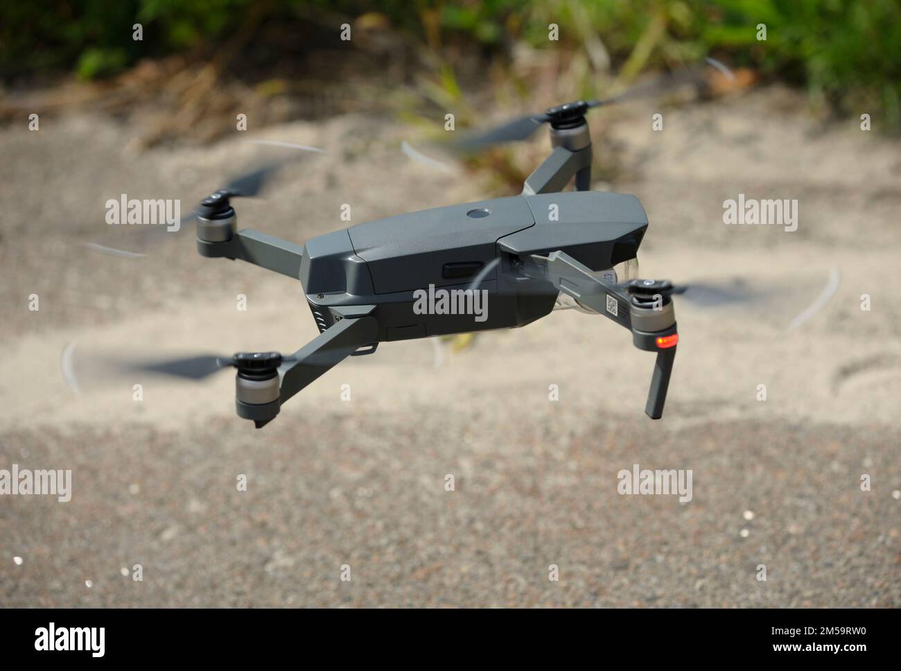 Quadcopter flying over the ground Stock Photo - Alamy