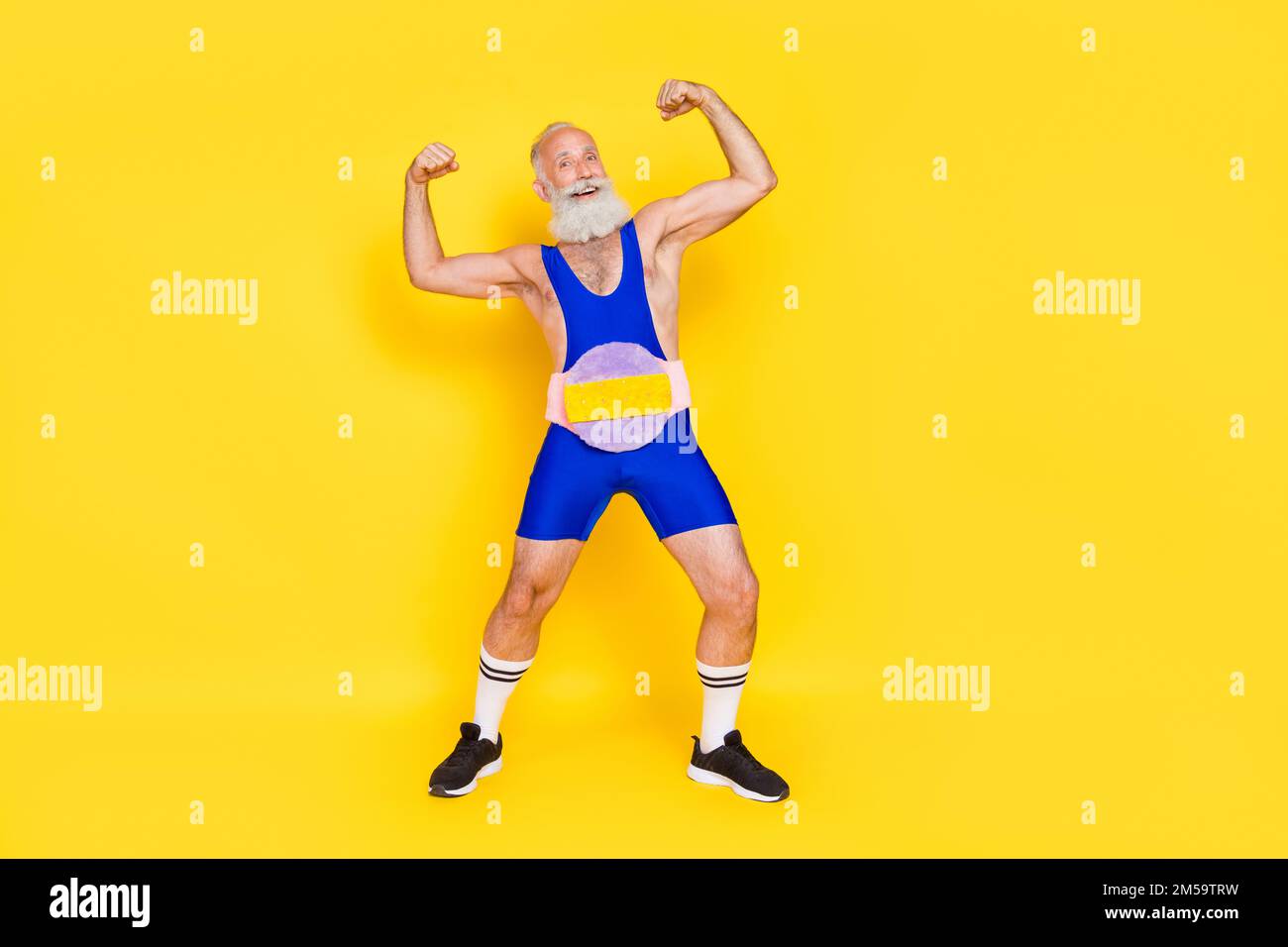 Full body portrait of cheerful muscular grandfather wear champion belt ...