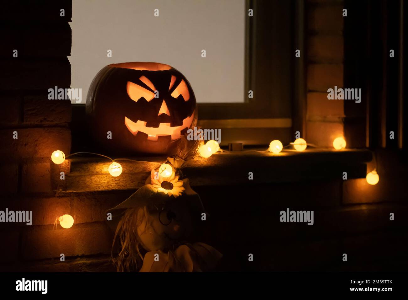 Spooky Halloween pumpkin, Jack O Lantern with pumpkins lights hanging ...