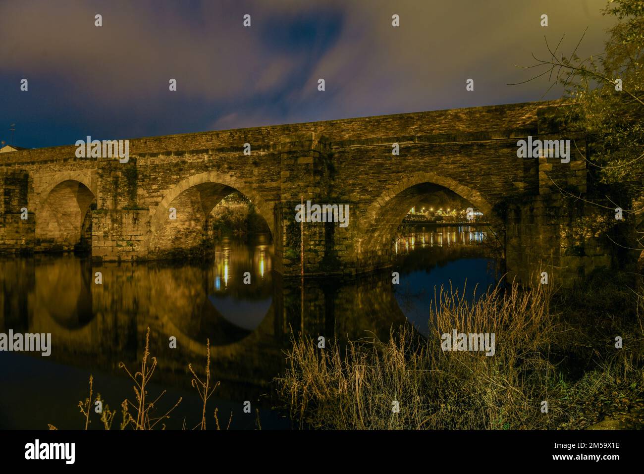night landscape of the Roman bridge of Lugo over the Minho river in ...
