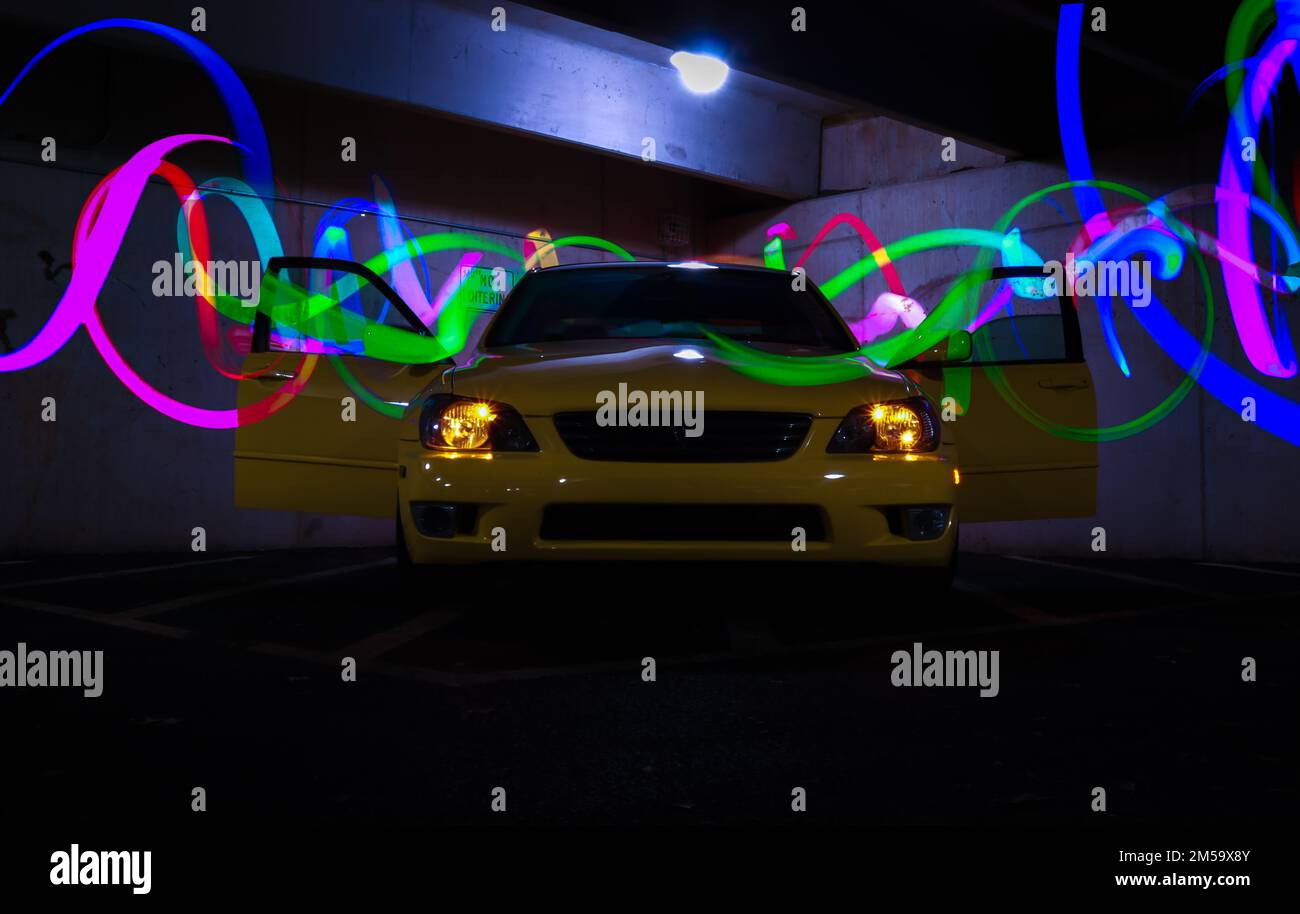 A drift Car parked in garage with neon lights floating around it Stock ...
