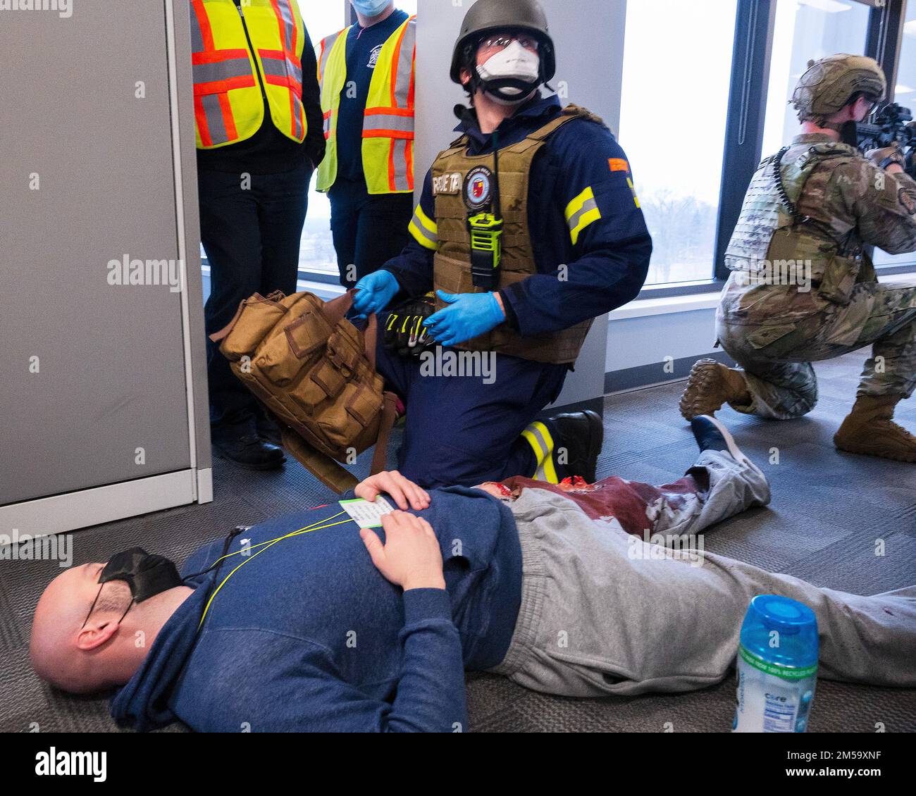 A paramedic with the rescue task force checks on a shooting “victim” as ...