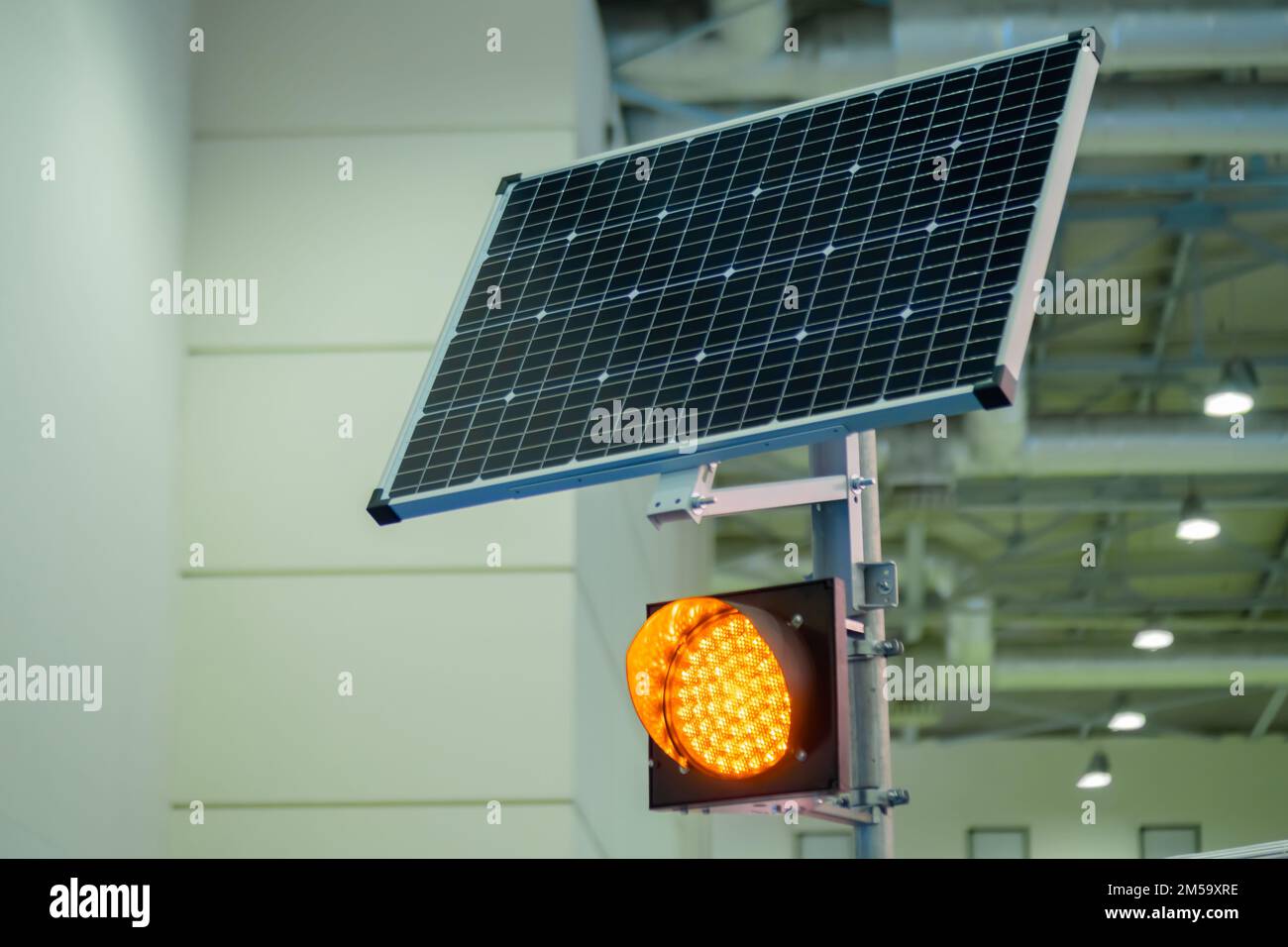 Single LED orange traffic light powered by solar panels at exhibition ...