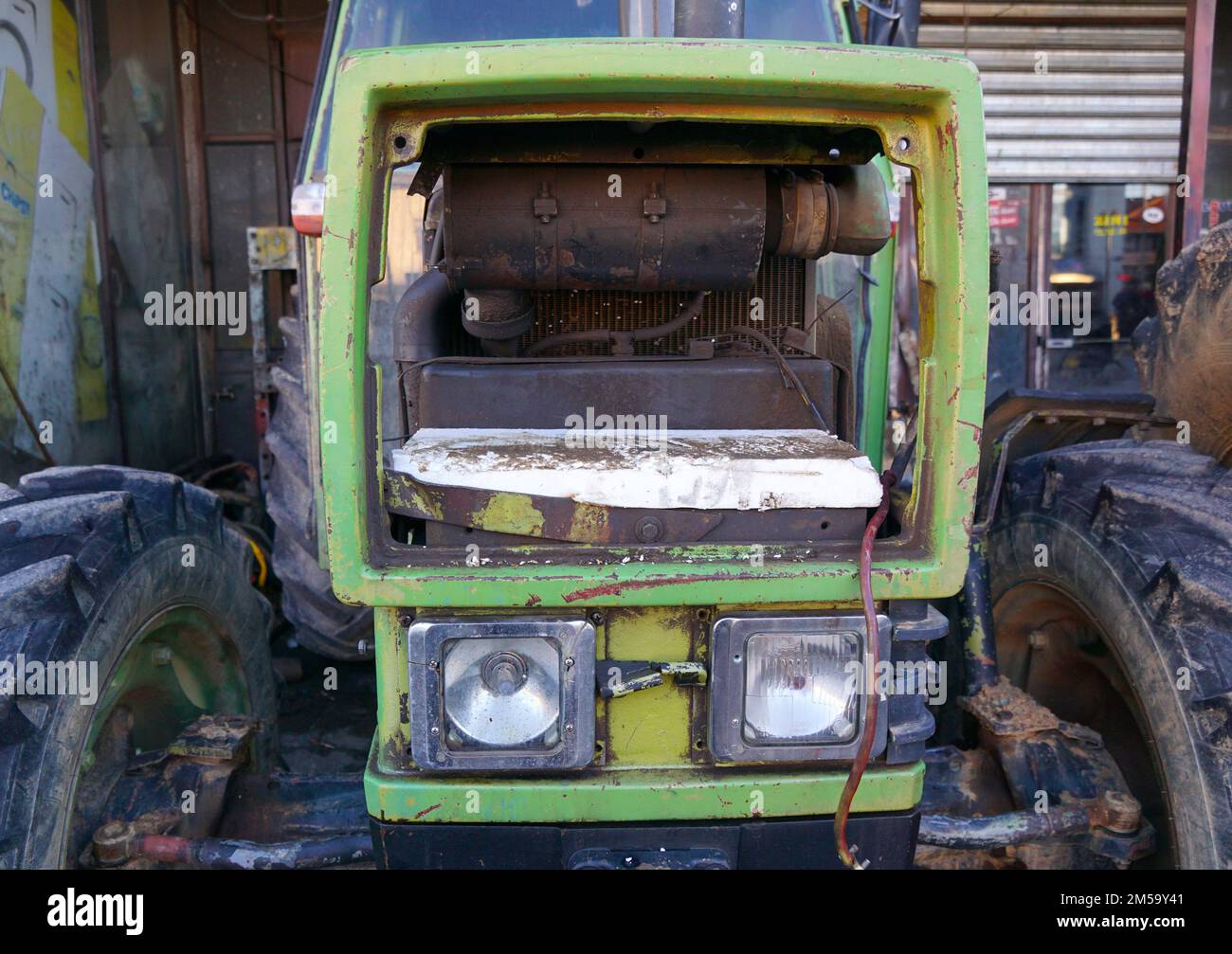 old tractor on the mechanic repair workshop Stock Photo - Alamy
