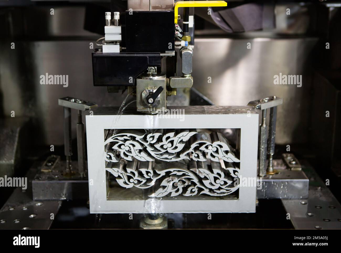 Electrical discharge machine EDM cutting metal workpiece in workshop ...