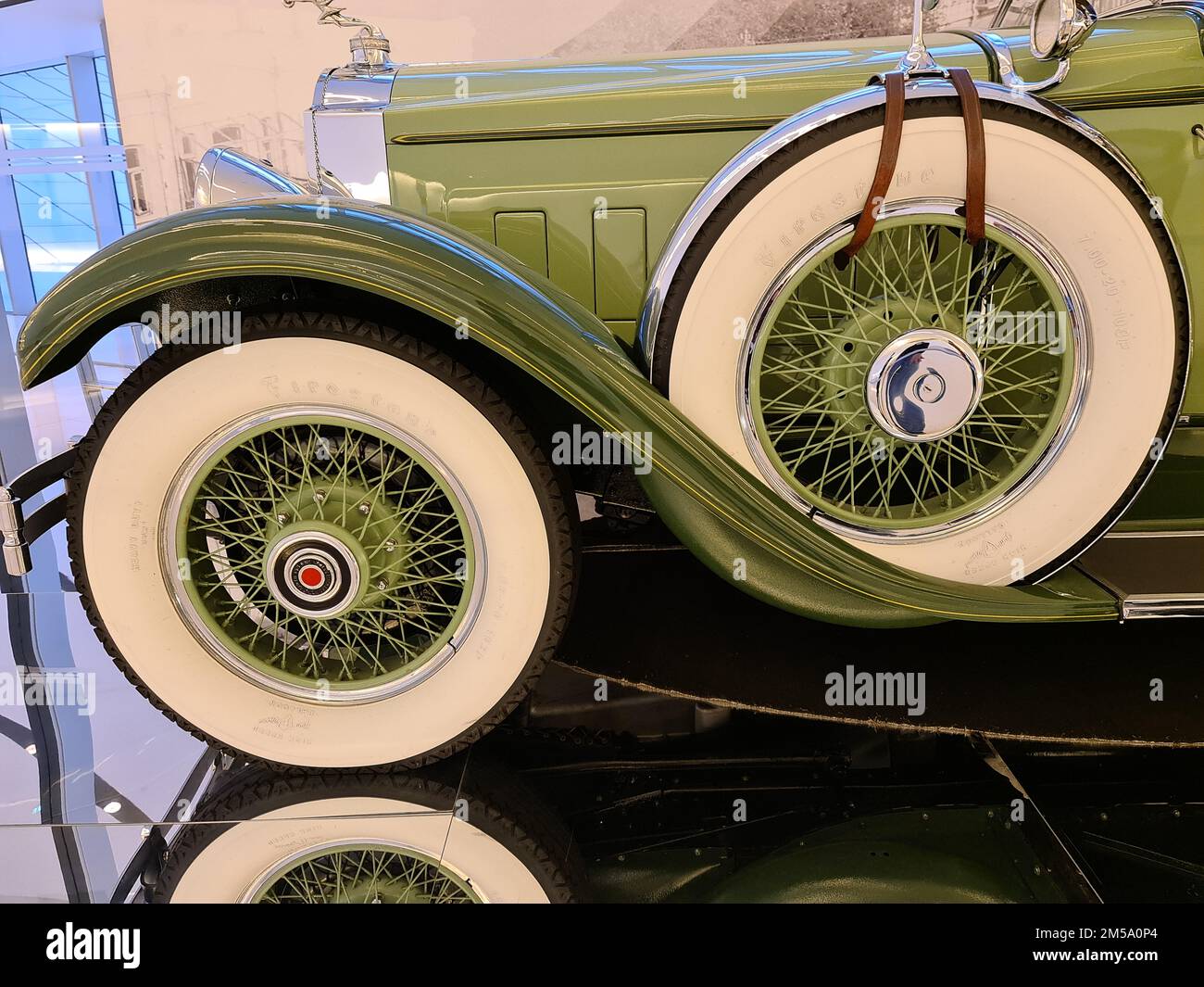 A green vintage car with a white wheel on the side Stock Photo - Alamy