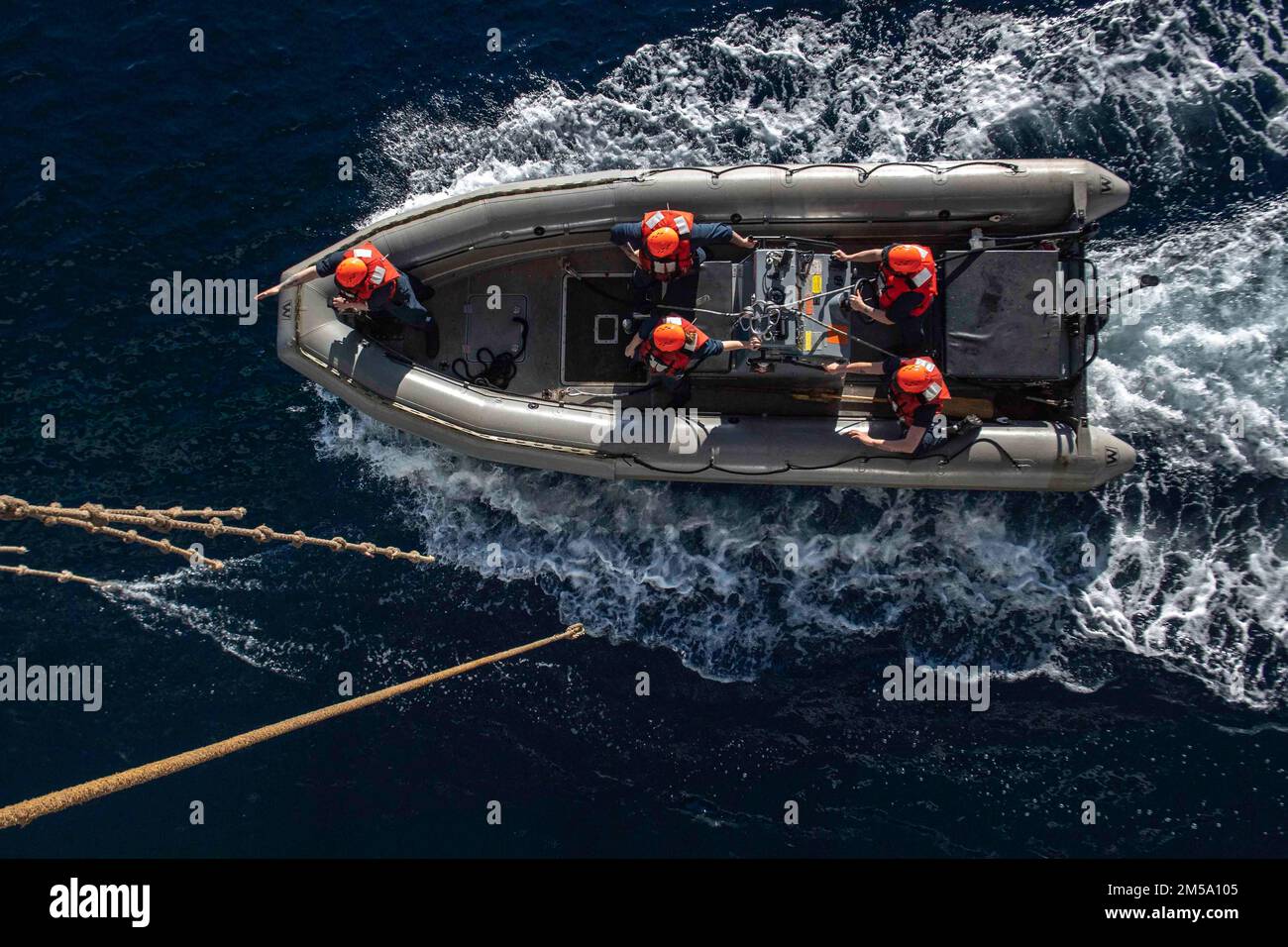 220213-N-XK462-1113 PACIFIC OCEAN (Feb. 13, 2022) Sailors grab lines ...