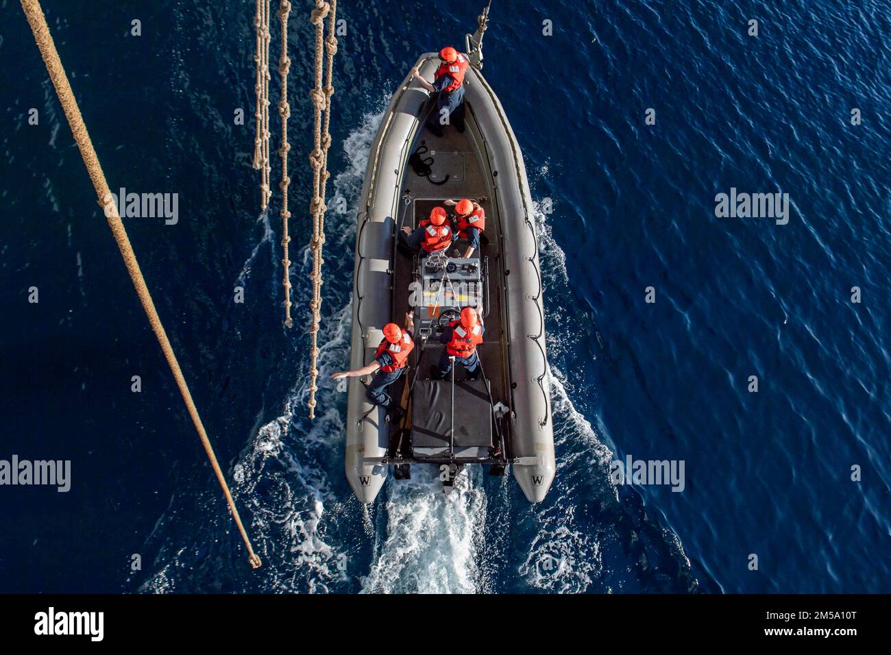 220213-N-XK462-1103 PACIFIC OCEAN (Feb. 13, 2022) Sailors grab lines ...