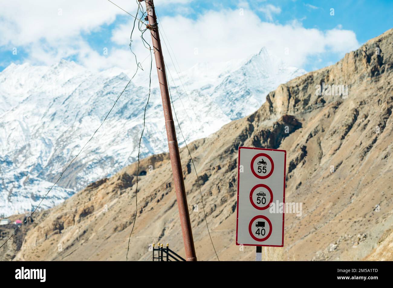Road sign warning against slippery road due to snow ice Stock Photo - Alamy