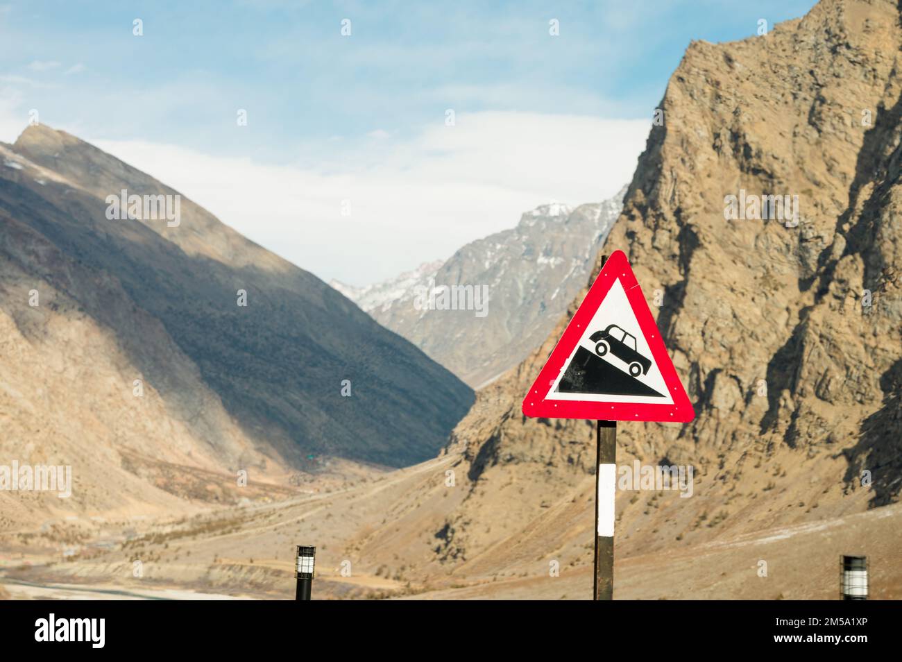 Road sign warning against slippery road due to snow ice Stock Photo - Alamy