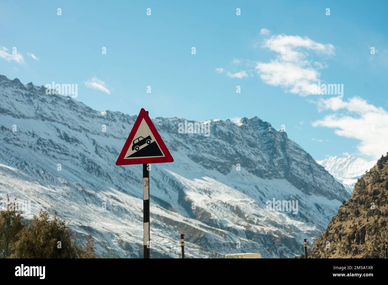 Road sign warning against slippery road due to snow ice Stock Photo - Alamy