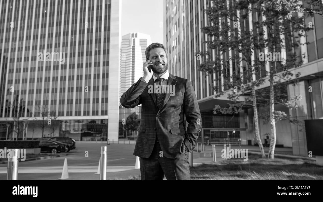 happy businessman speak on smartphone. man boss has conversation ...