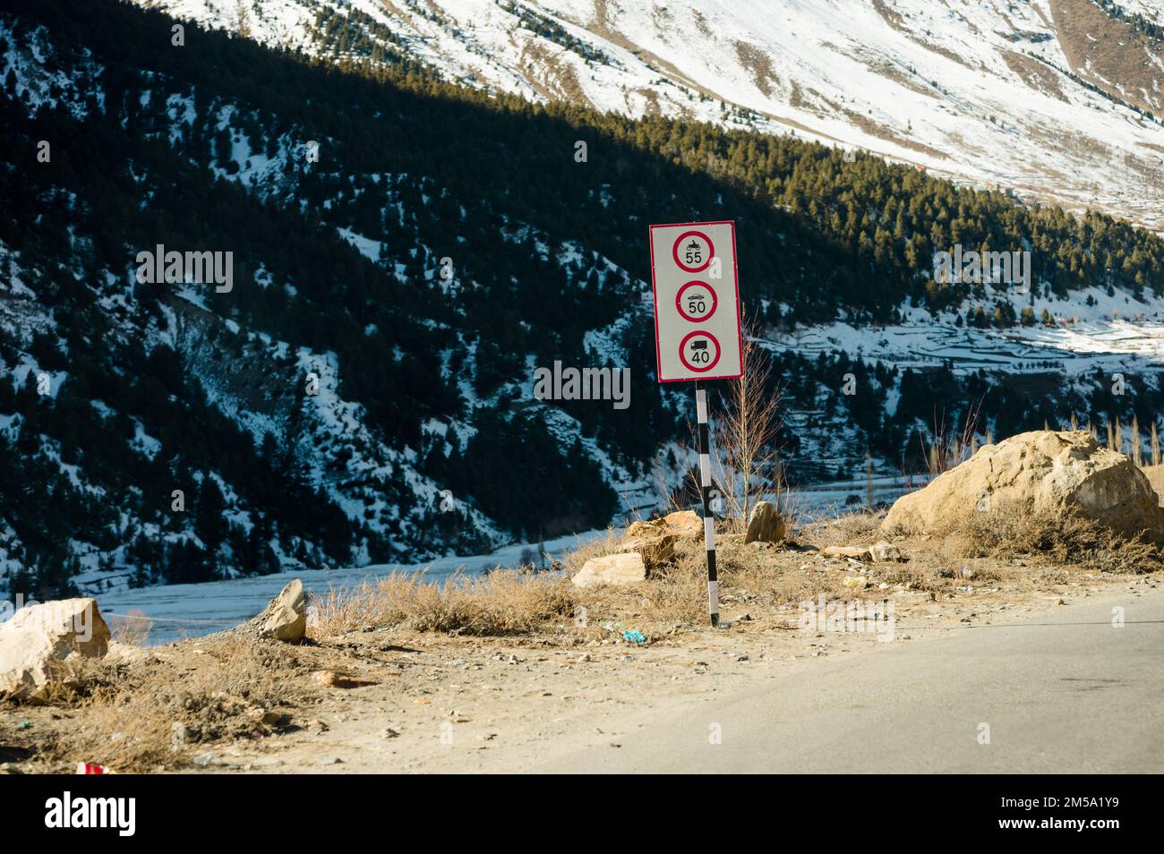 Road sign warning against slippery road due to snow ice Stock Photo - Alamy