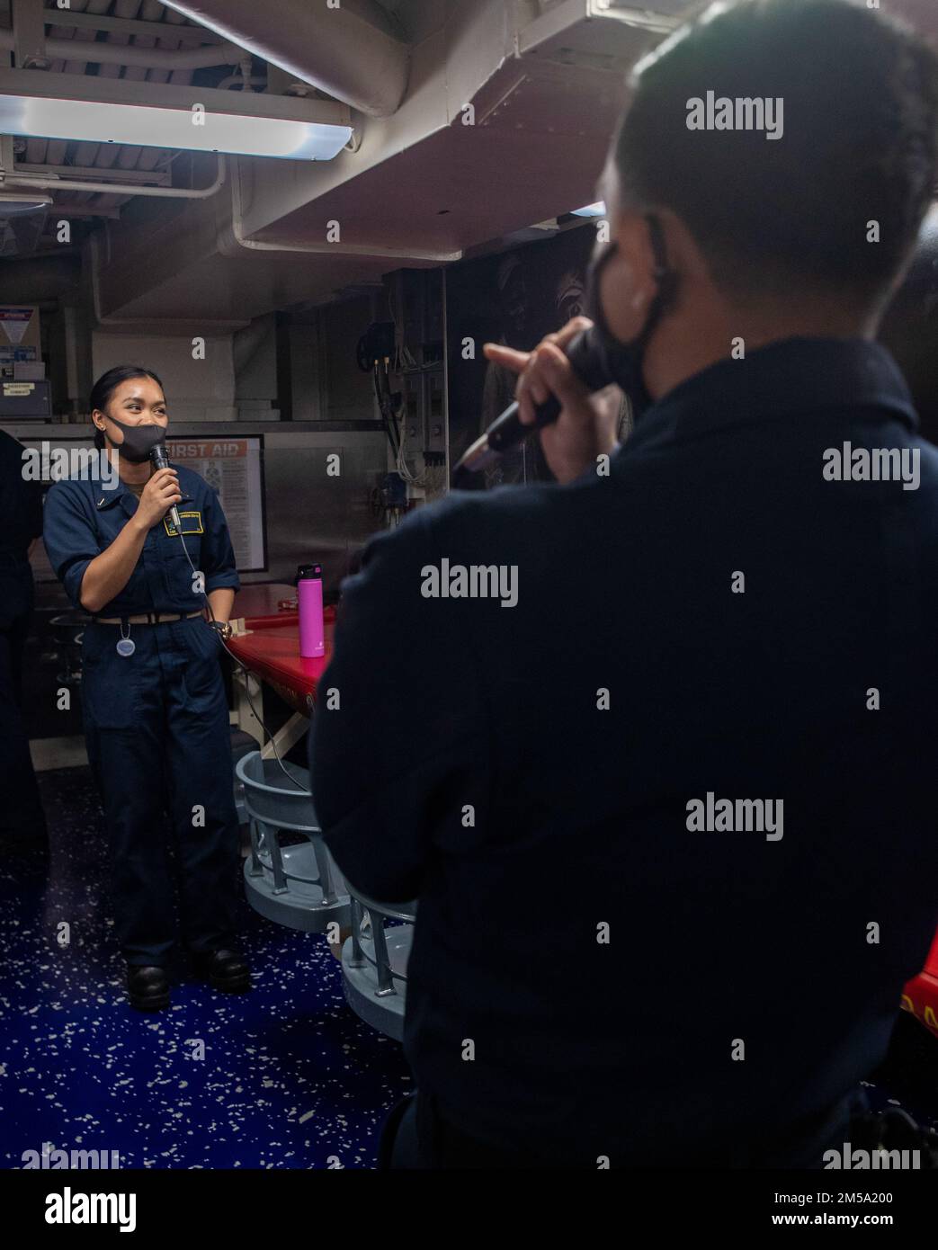 SOUTH CHINA SEA (Feb. 13, 2022) Ensign Sydney Tse (left), from Bayonne ...