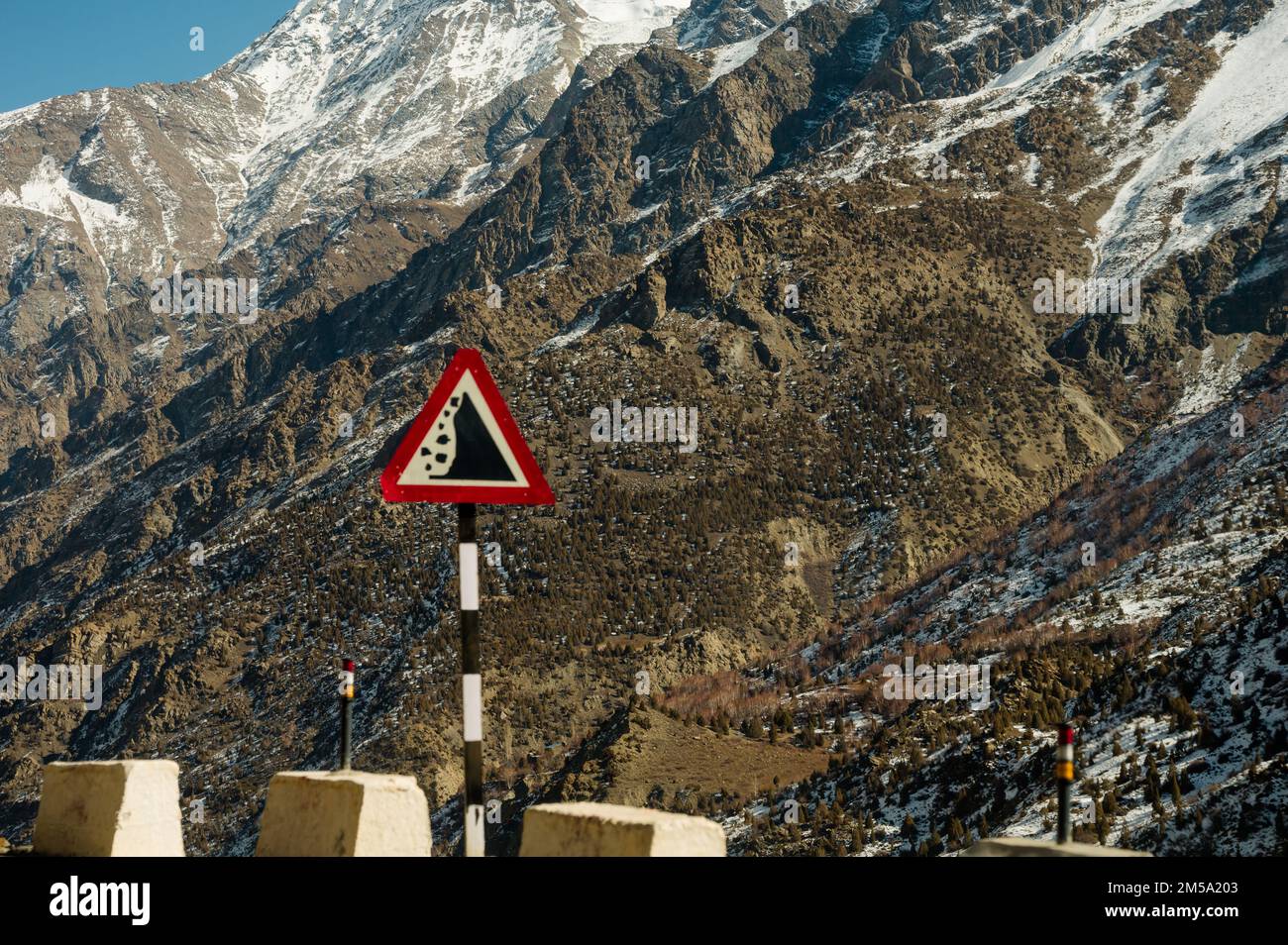 Road sign warning against slippery road due to snow ice Stock Photo - Alamy